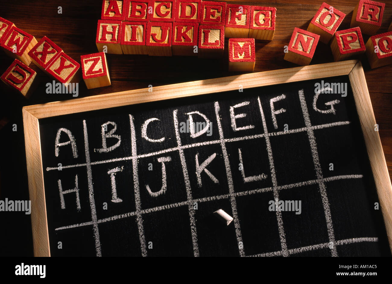 Letter blocks and alphabet written on a school slate Stock Photo - Alamy