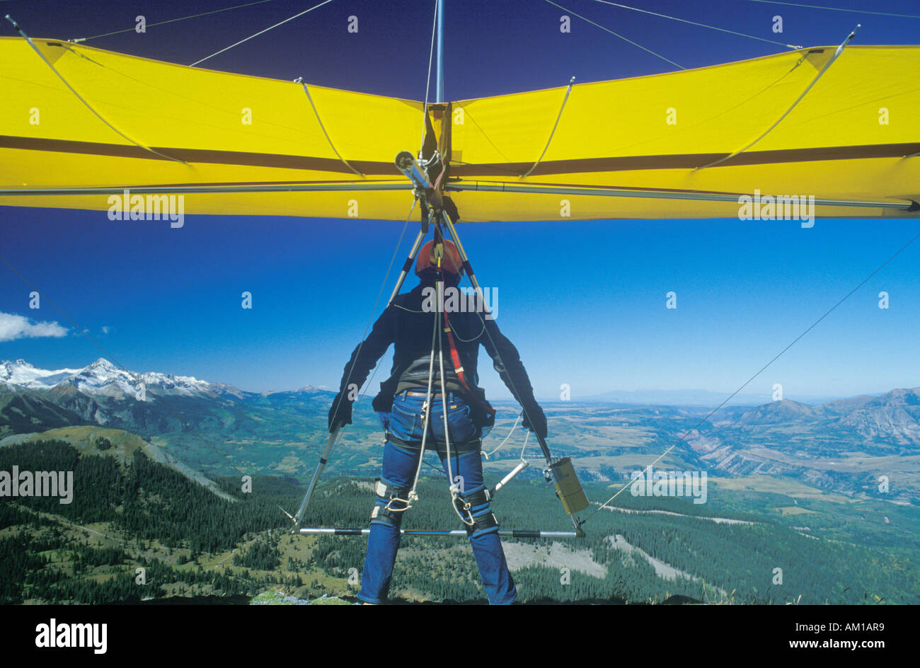 Rear view Close up of Hang Glider taking off of cliff in mid air during ...