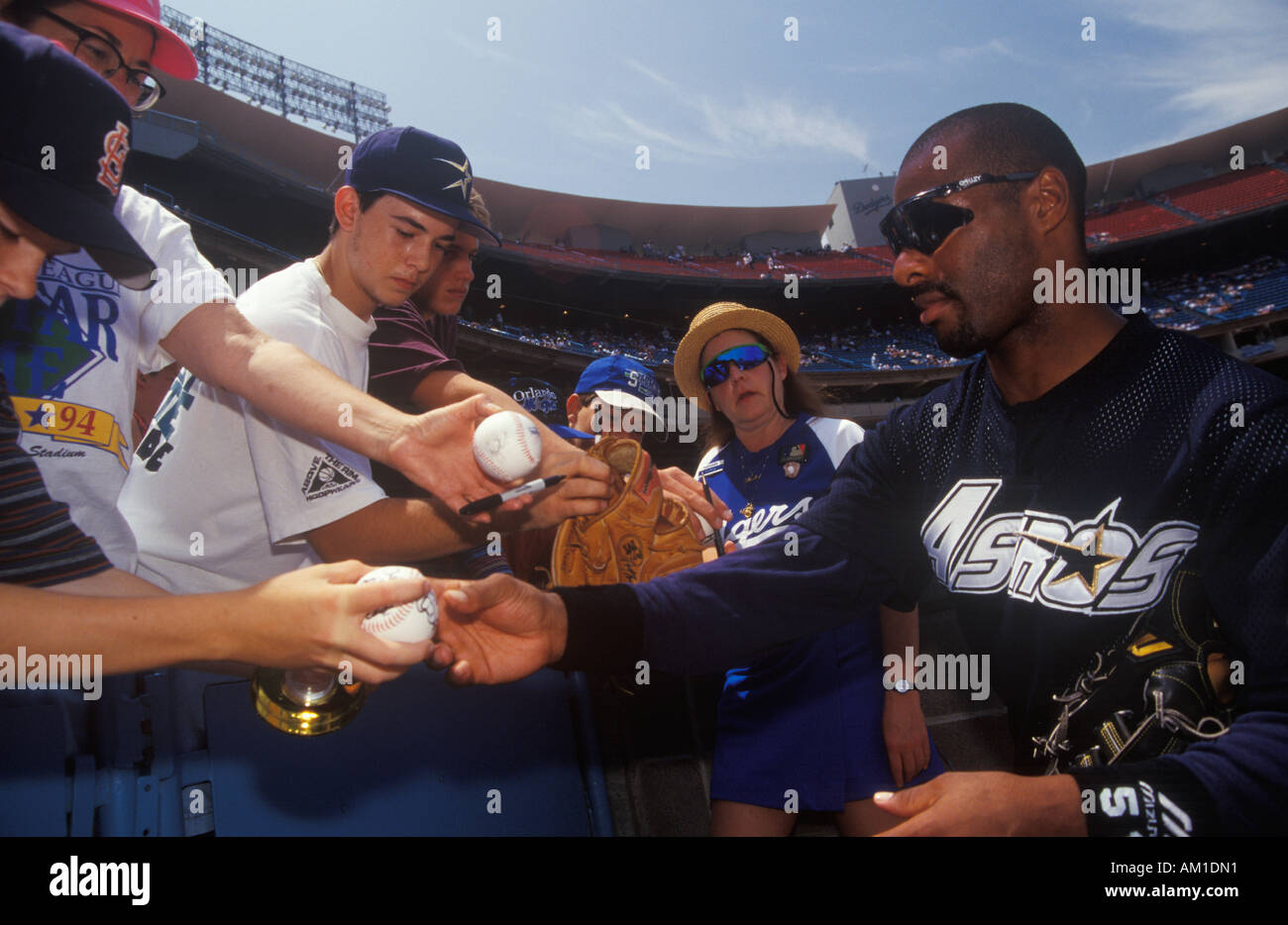 Professional Baseball player signing autographs and balls for young ...
