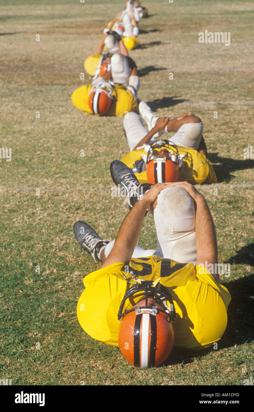 Football players warming up with stretches on field prior to Game ...