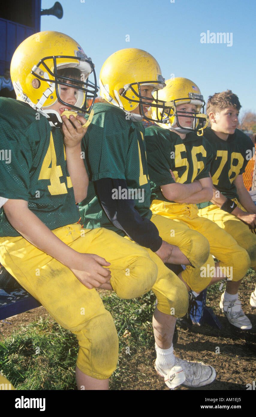 Micro league football players aged 8 to 11 sitting on bench during game ...