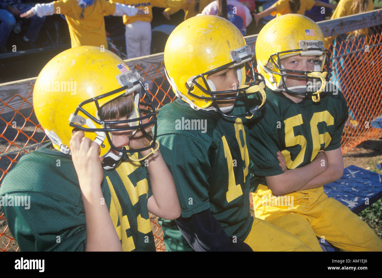 Micro league football players aged 8 to 11 sitting on bench during game ...