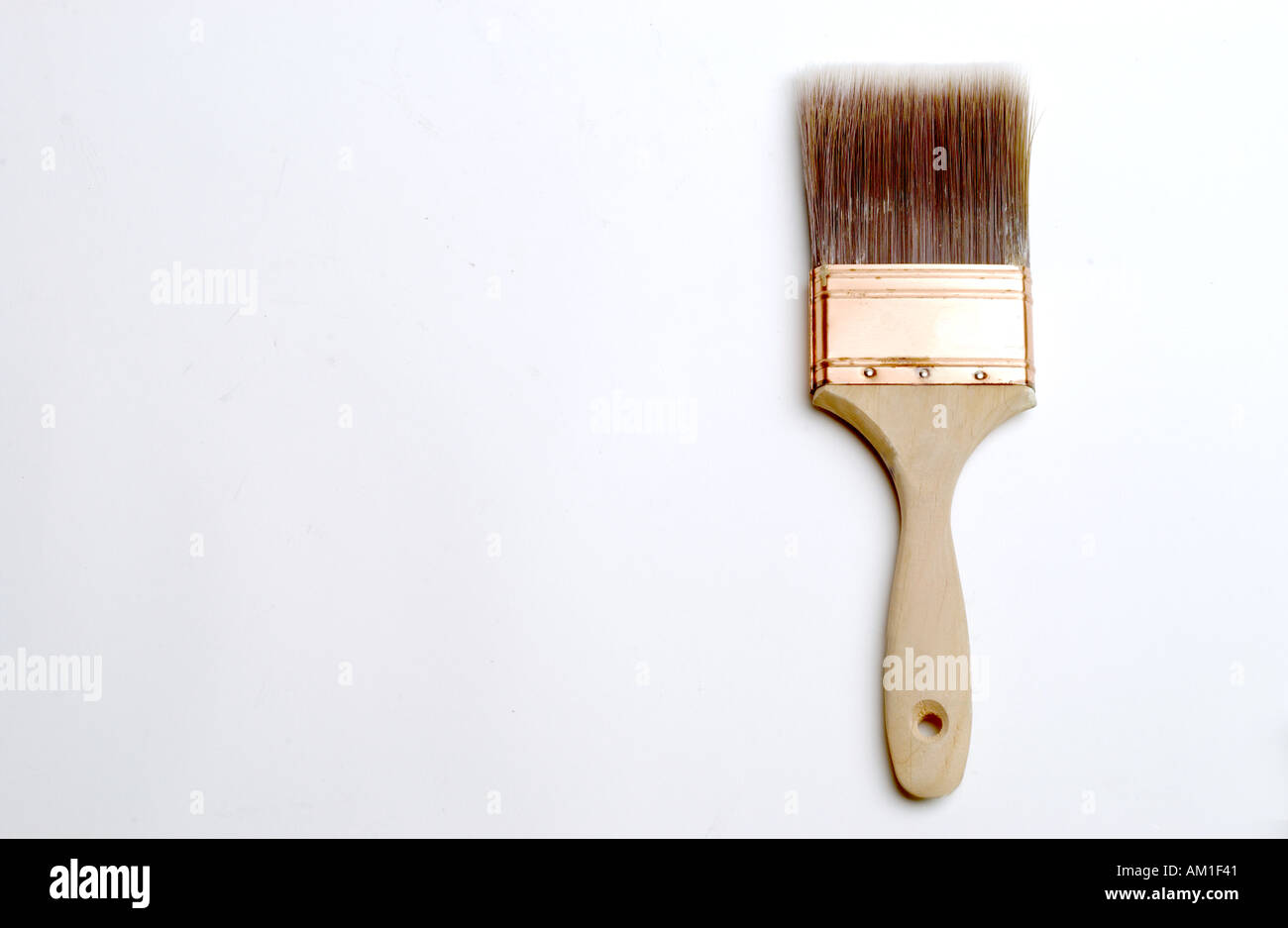 Horizontal color image of a wood handle paint brush on a white ...