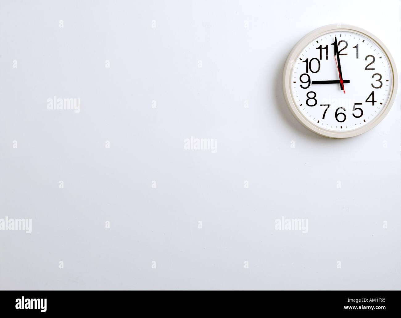 Horizontal color image of a clock on a white wall Stock Photo - Alamy