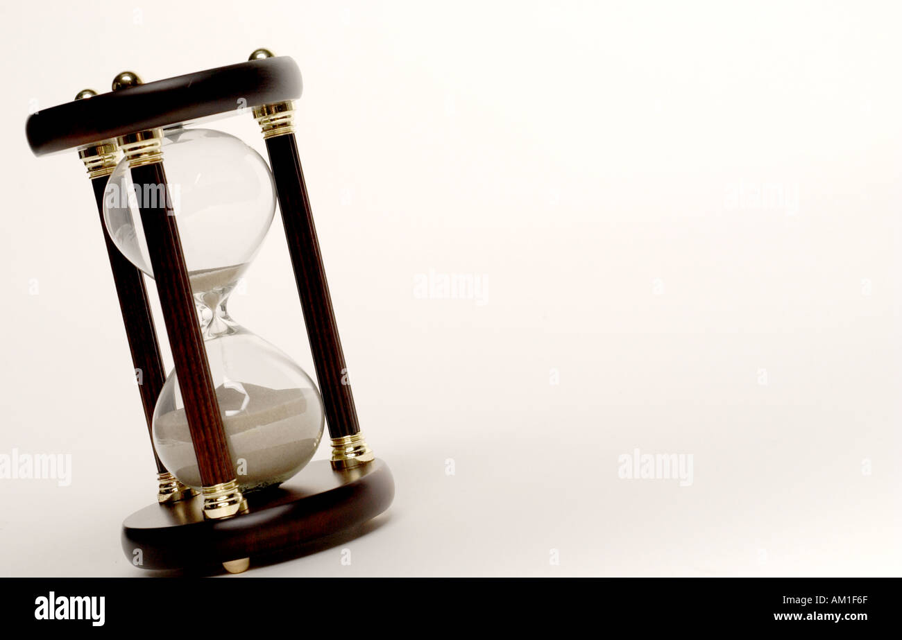 Horizontal color image of an hour glass against a white background ...