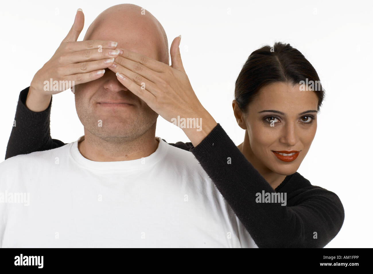 Woman hides eyes of man Stock Photo - Alamy