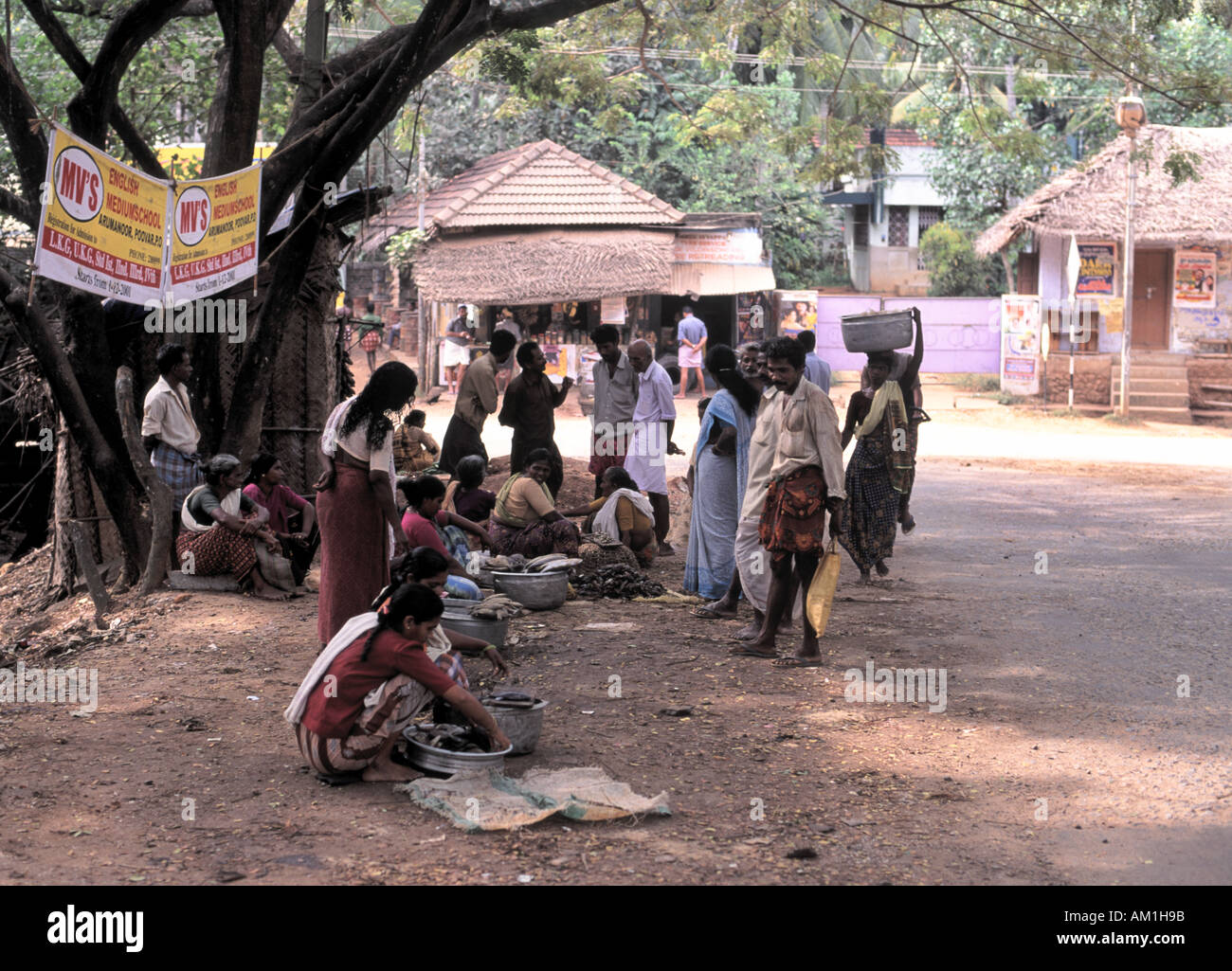 Poovar, Kerala, India in the primitive local food market, traders squat ...