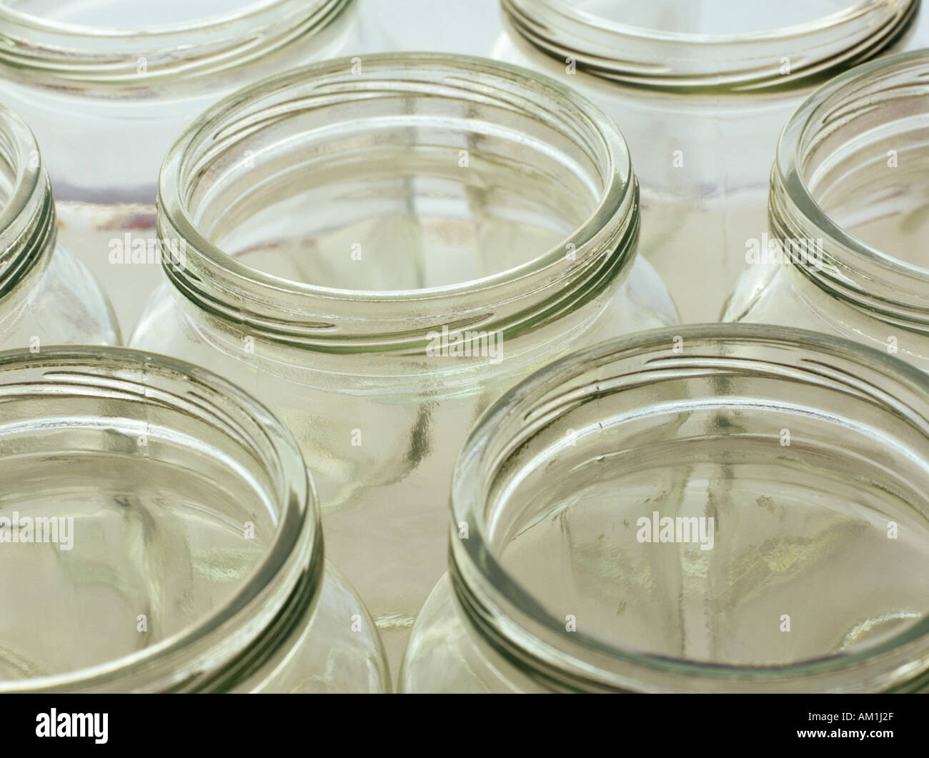 empty clear glass jam jars with a neutral background Stock Photo - Alamy