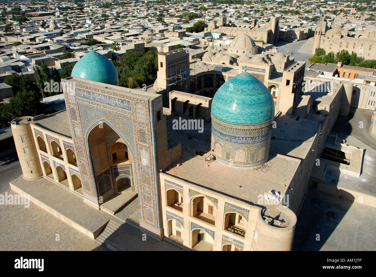 View over the blue cupolas of Mir-i Arab Madrasah and roofs of the city from minaret Kalon ...