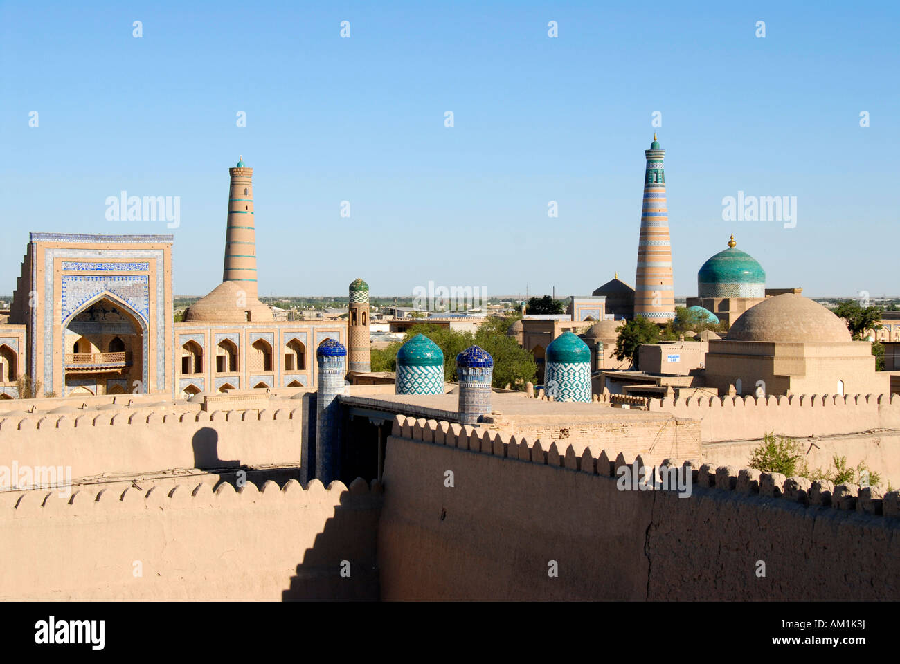 View of the high minarets and blue cupolas in the old town Khiva ...