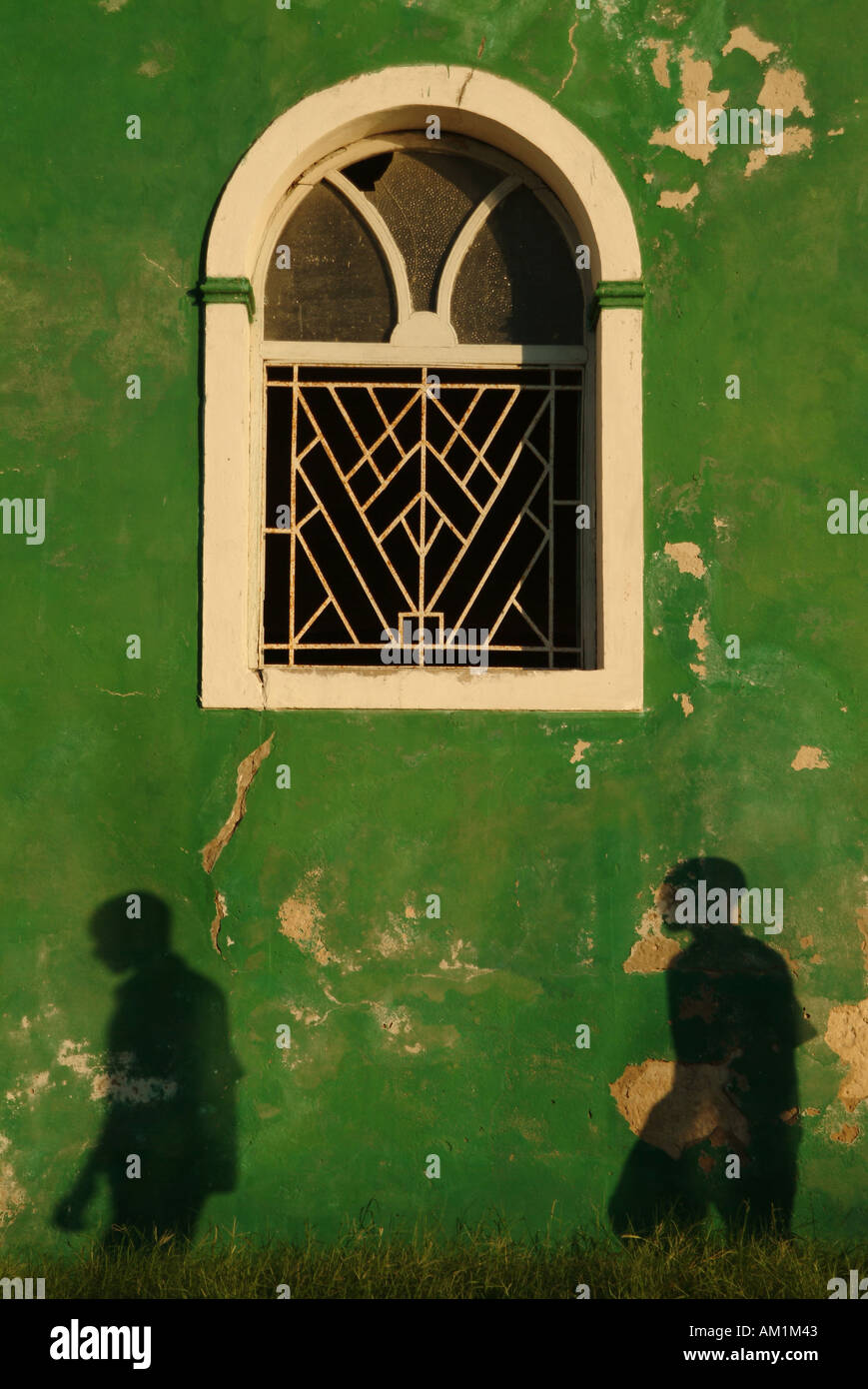 Shadows of local Africans reflect on the green mosque which stands on ...