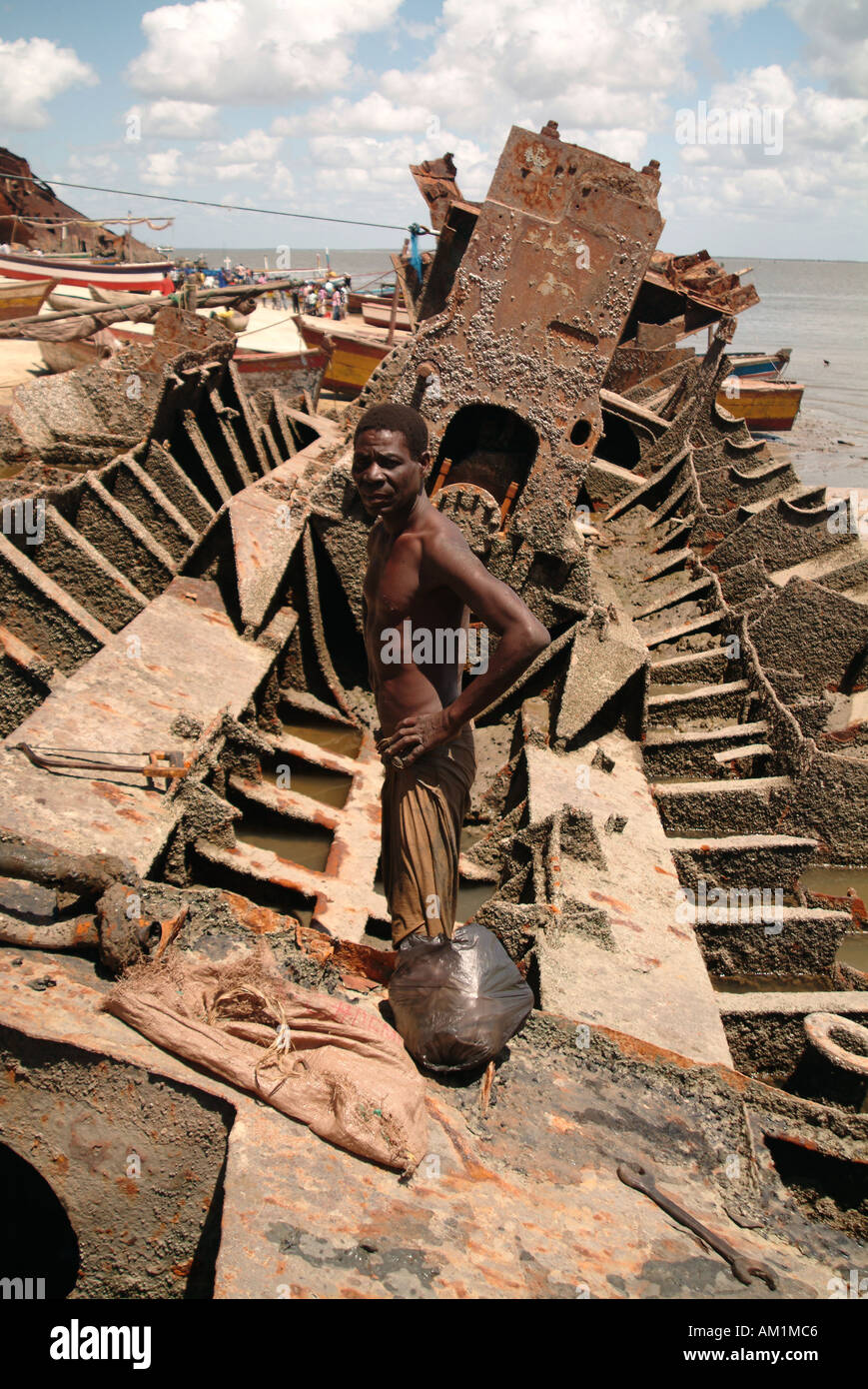 A scrap yard worker at ship graveyard on Beira beach in Mozambique ...