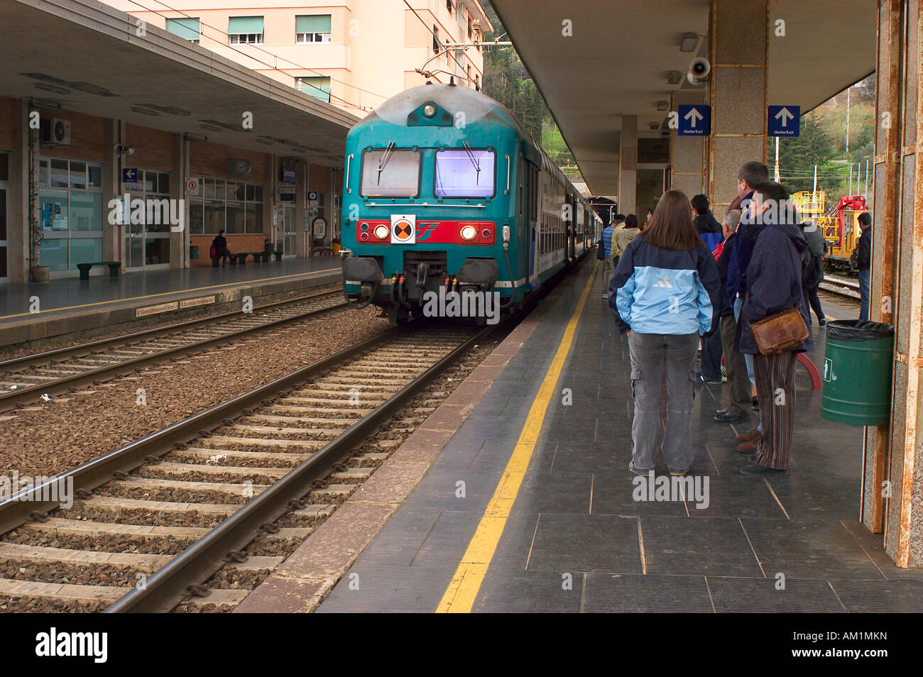 Tourists waiting for the regional train at the station of Levanto ...