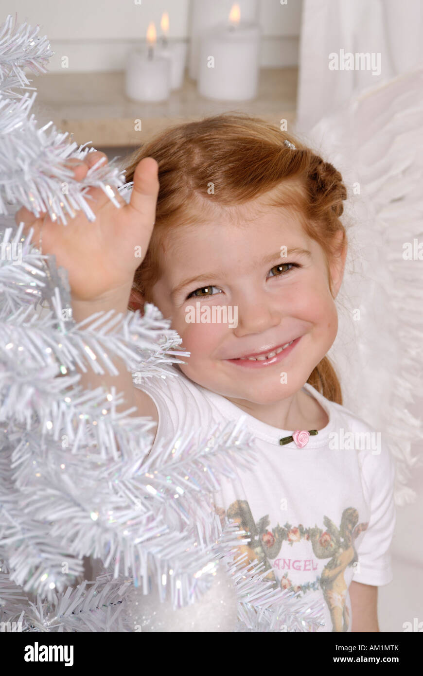 Child decorates a white christmas tree Stock Photo - Alamy