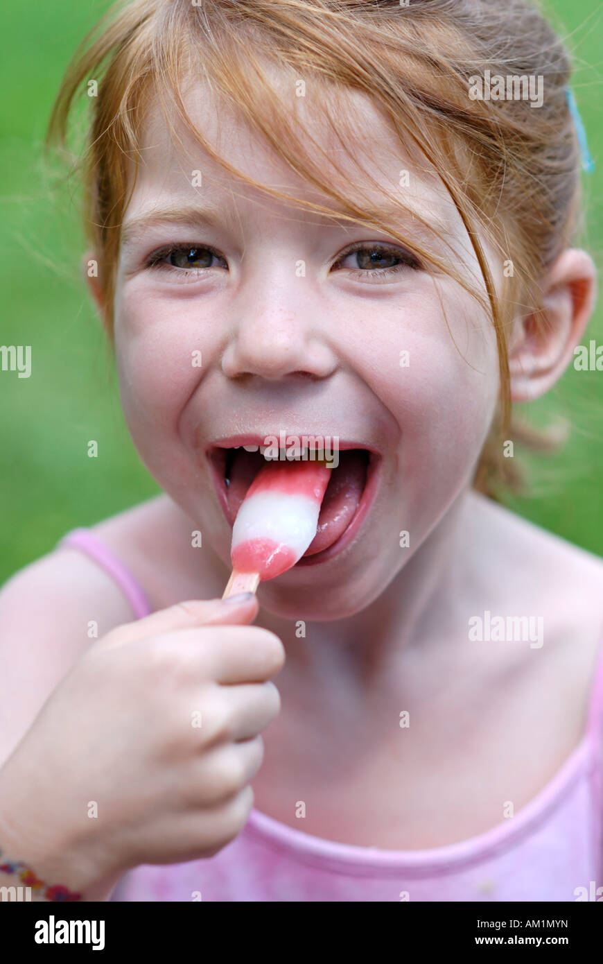 Little girl eating ice cream iced lolly Stock Photo - Alamy