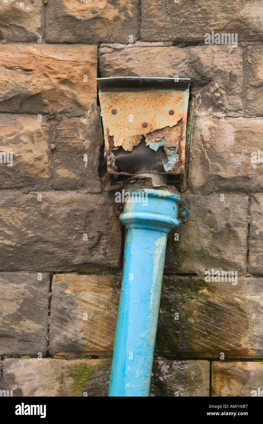 an old victorian rusting drainpipe on the side of an abandoned cotton ...