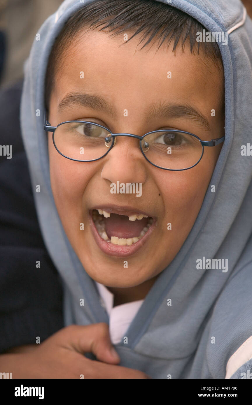 An asian child on the streets of burnley Lancashire with his teeth ...