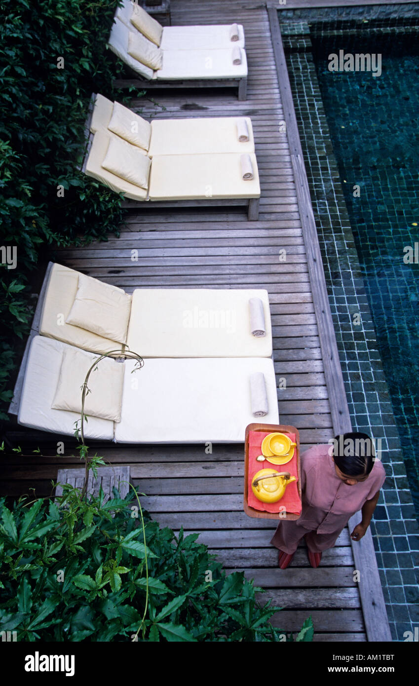 Indonesia, Bali, Jimbaran, Villa Balquisse Hotel, waitress at poolside ...