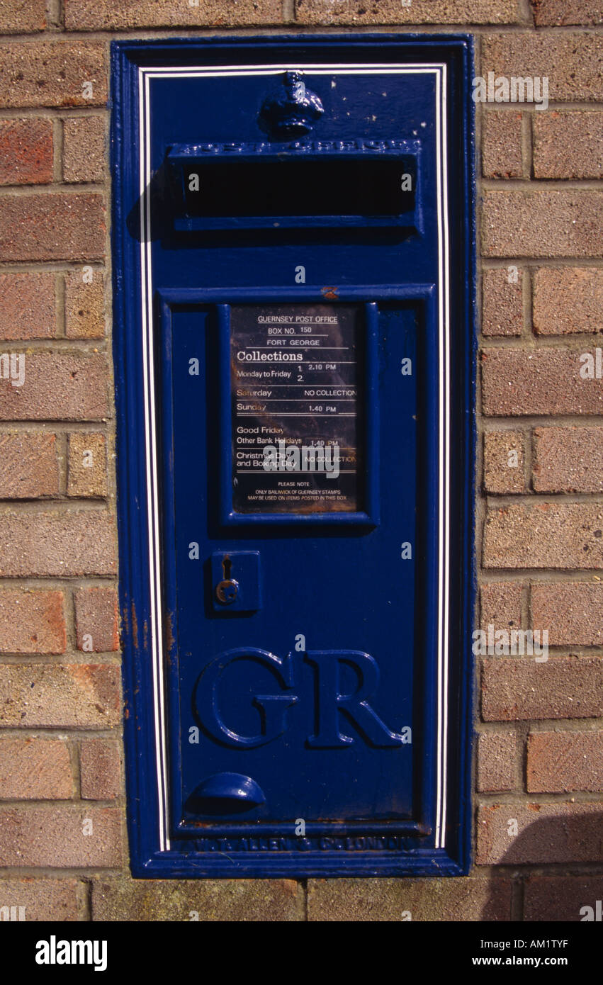Traditional blue Guernsey post box mounted in a wall, Guernsey, Channel ...