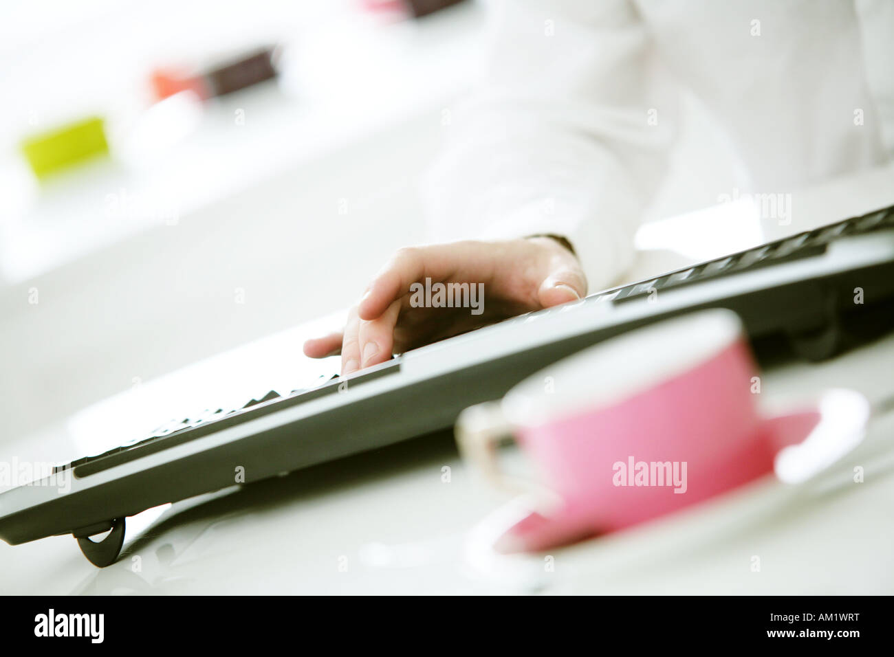 Mans hand on computer keyboard in light white office Stock Photo - Alamy