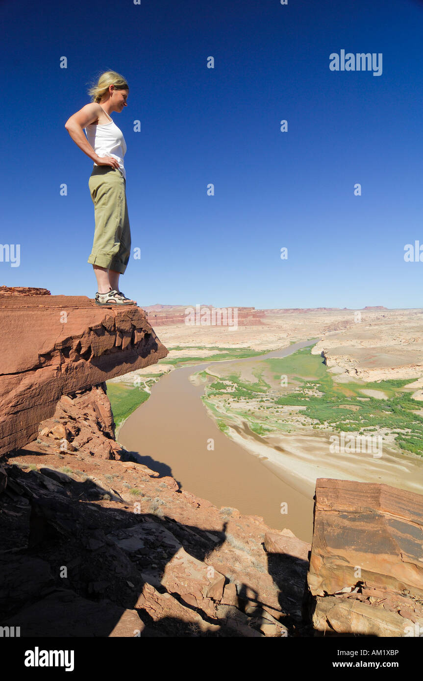 Woman standing on a ledge, looking over Glen Canyon National Recreation ...