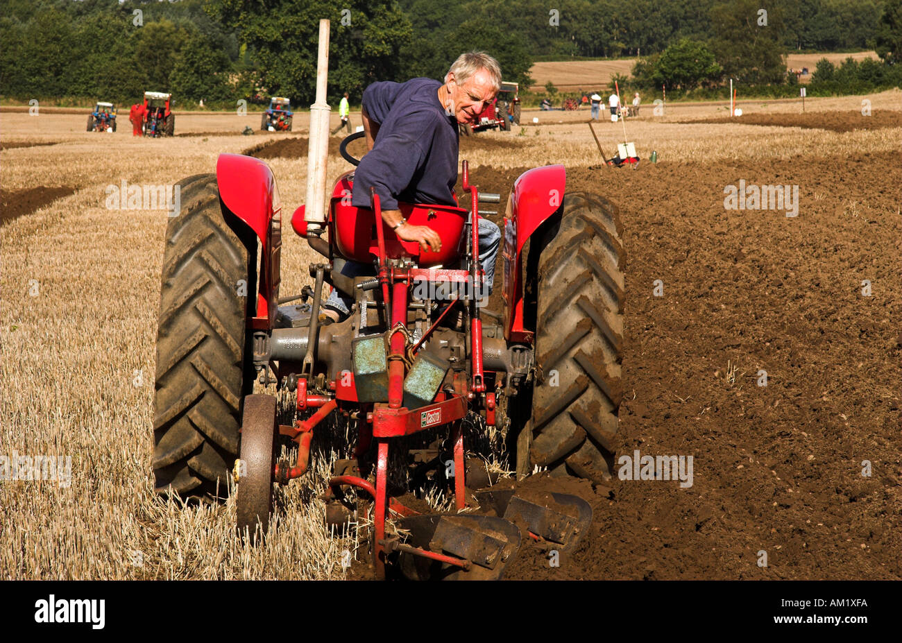 CHECKING THE FURROWS A farmer checks his ploughing from his tractor ...