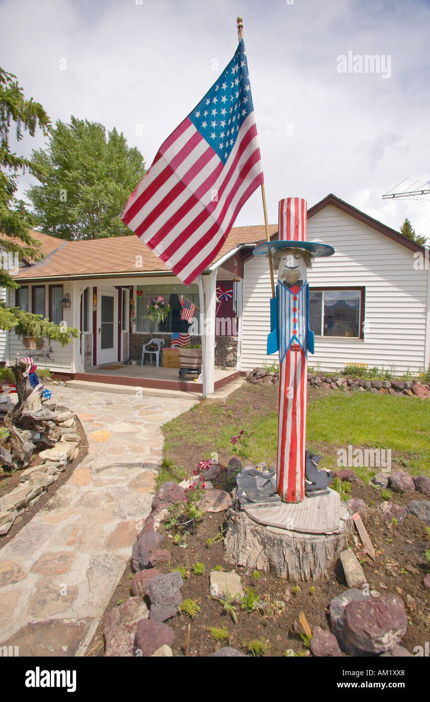 Country home with an Uncle Sam wood carving and American flag Stock ...