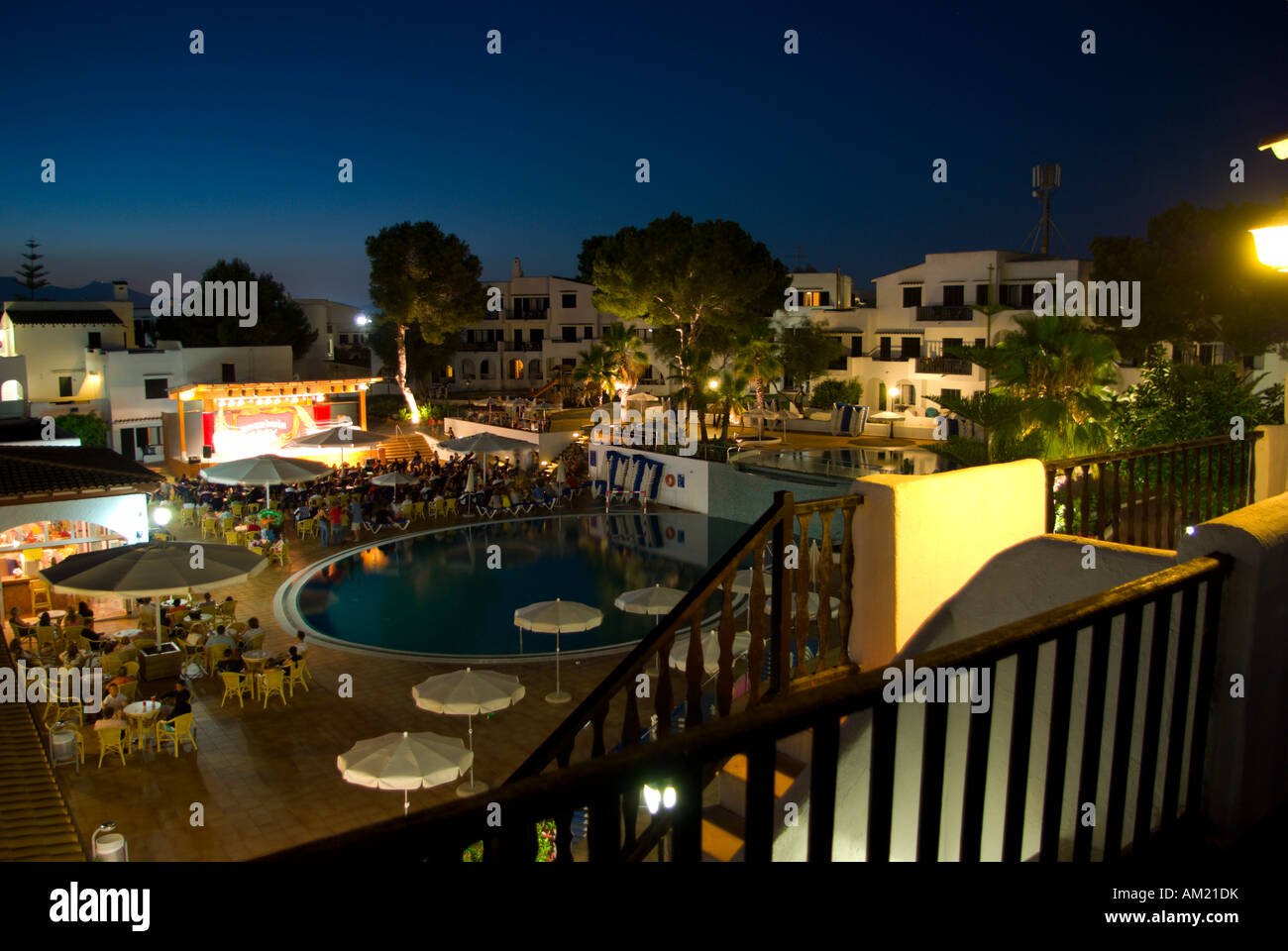 Hotel and swimming pool at night Stock Photo - Alamy