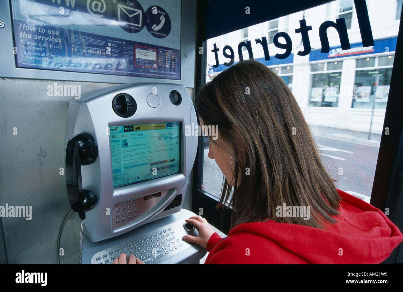 England Young woman using a public BT Internet phone booth Stock Photo ...
