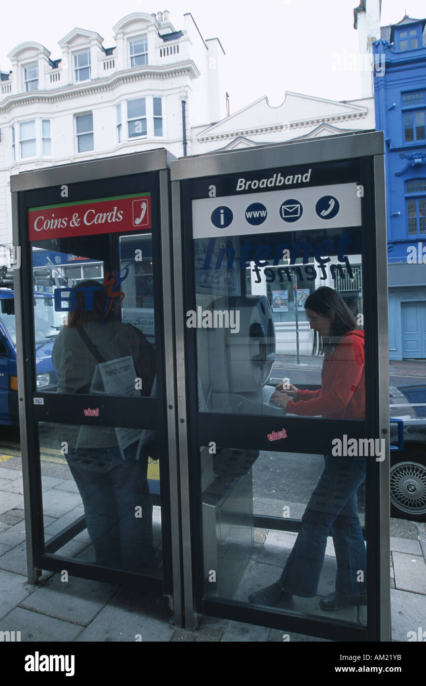 England Young woman using a public BT Internet phone booth Stock Photo ...