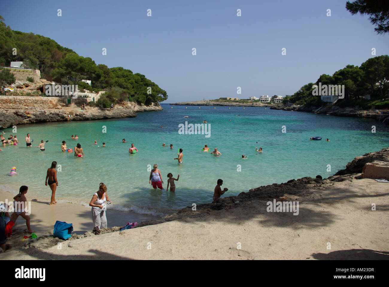 People swimming and playing on the beach in Cala d Or east coast of ...
