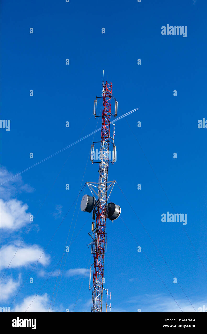 Communication tower with airplane contrail Stock Photo - Alamy
