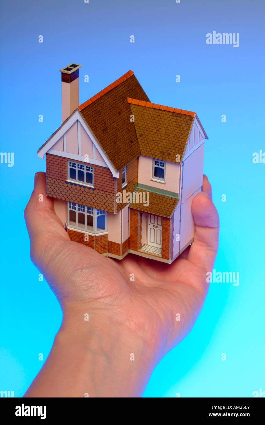 Hand holding model house Stock Photo - Alamy