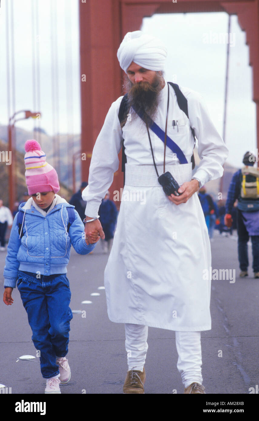 Eastern religious person walking across the Golden Gate Bridge in San ...