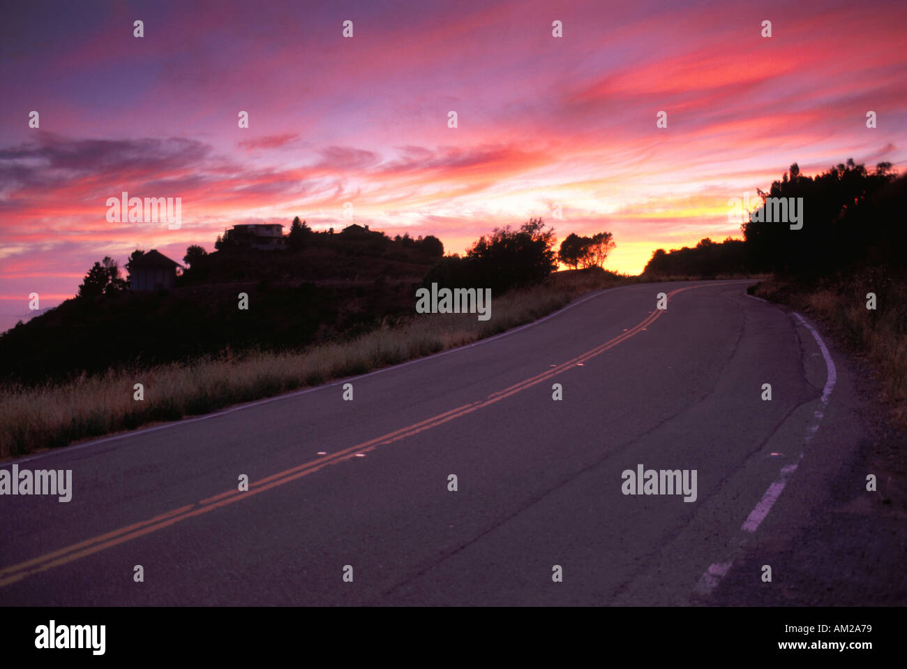 Red clouds at sunset over two lane twisting curved road Skyline Drive ...