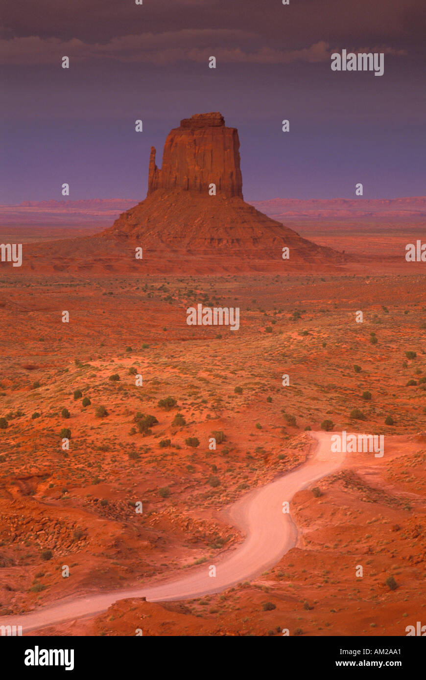 Dirt Road Red clouds sky and open flat desert at sunset Mitten Buttes ...