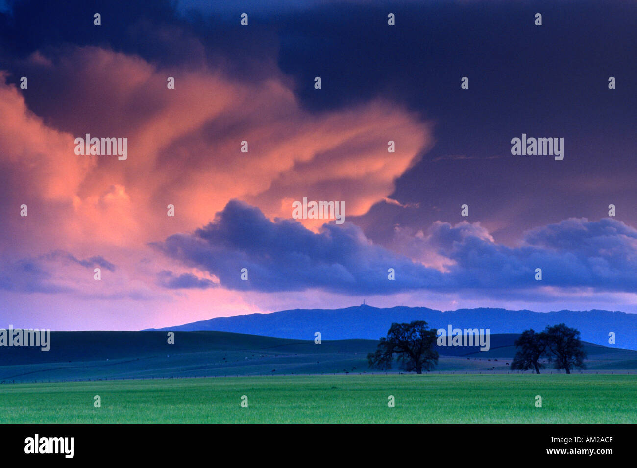 Dark clouds above agriculture field and hill hi-res stock photography ...
