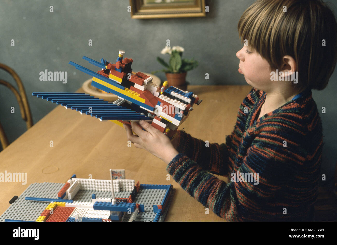 7 yr old boy playing with lego Stock Photo - Alamy