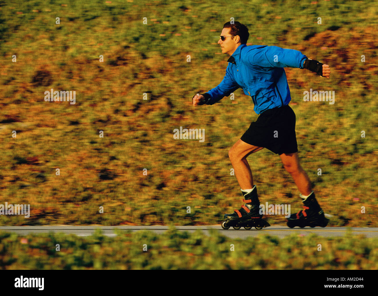 A man inline skating on a beach path Stock Photo - Alamy