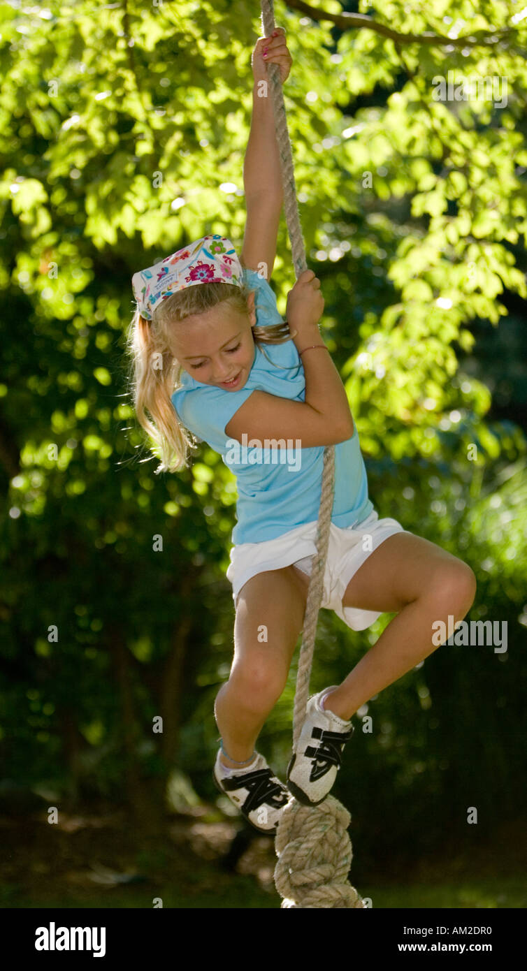 Child climbing a rope on a tree Stock Photo - Alamy