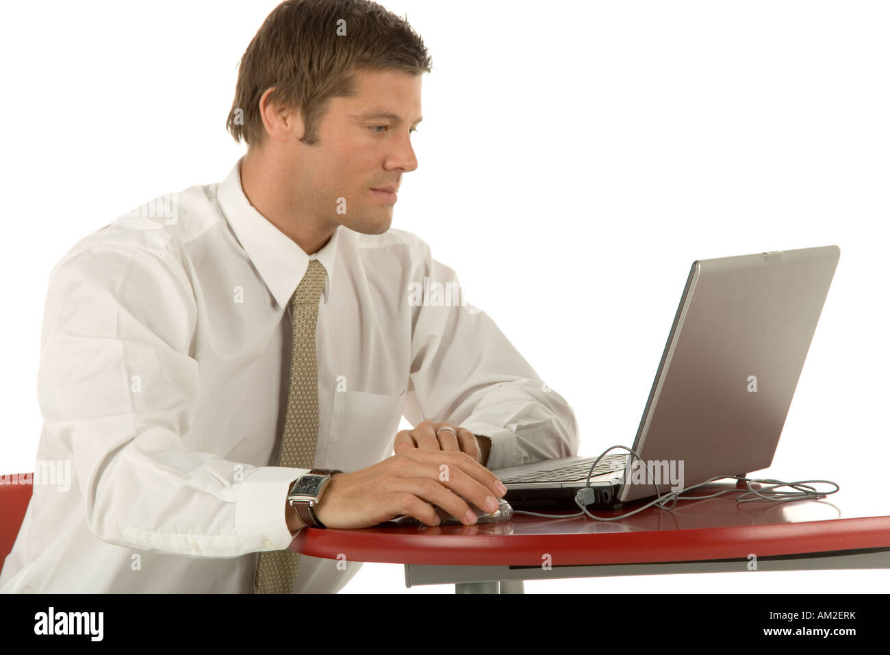 Young man working on a laptop computer against a white background Stock ...