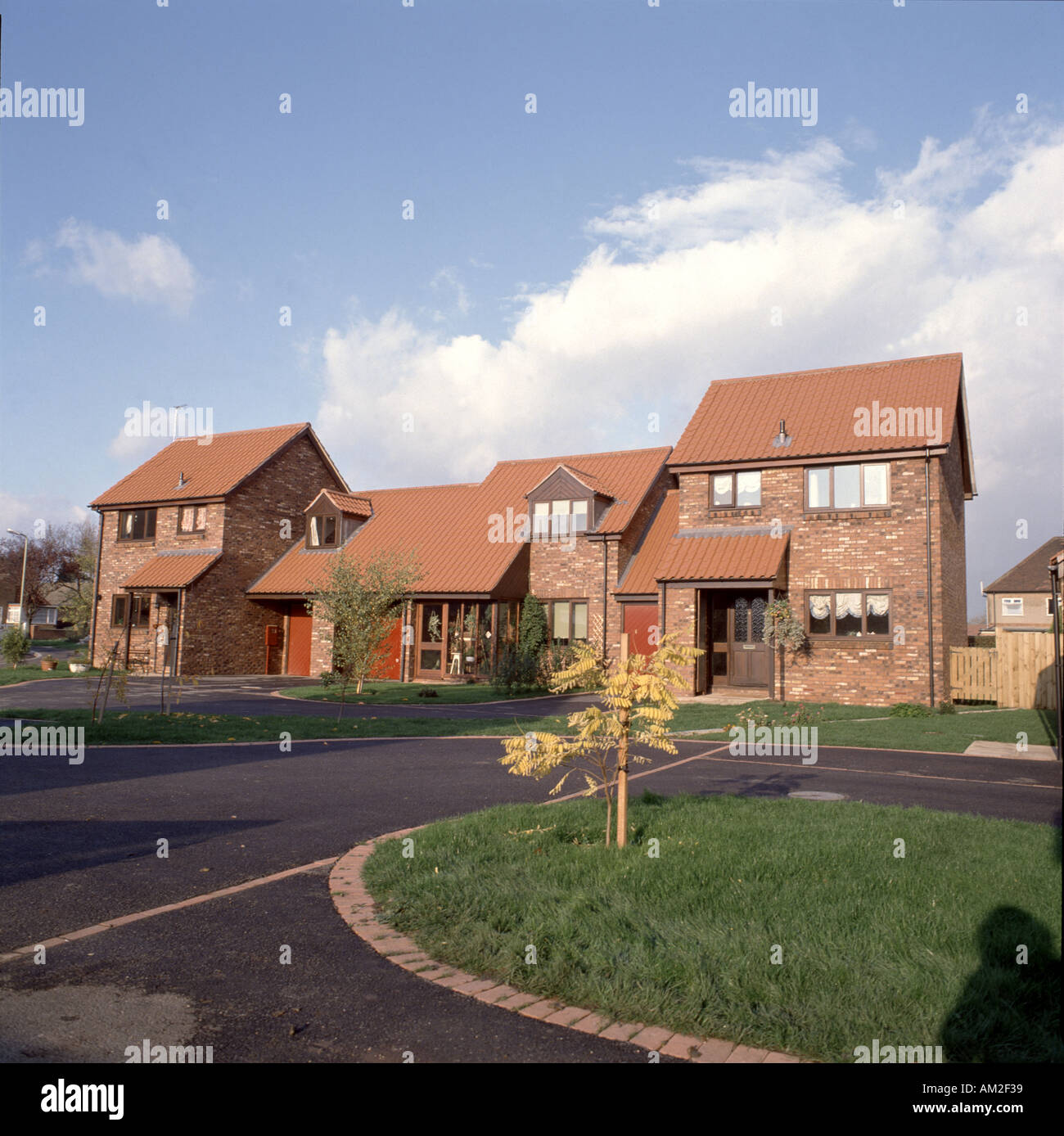 Typical red brick housing estate with pitched roofs and integral ...