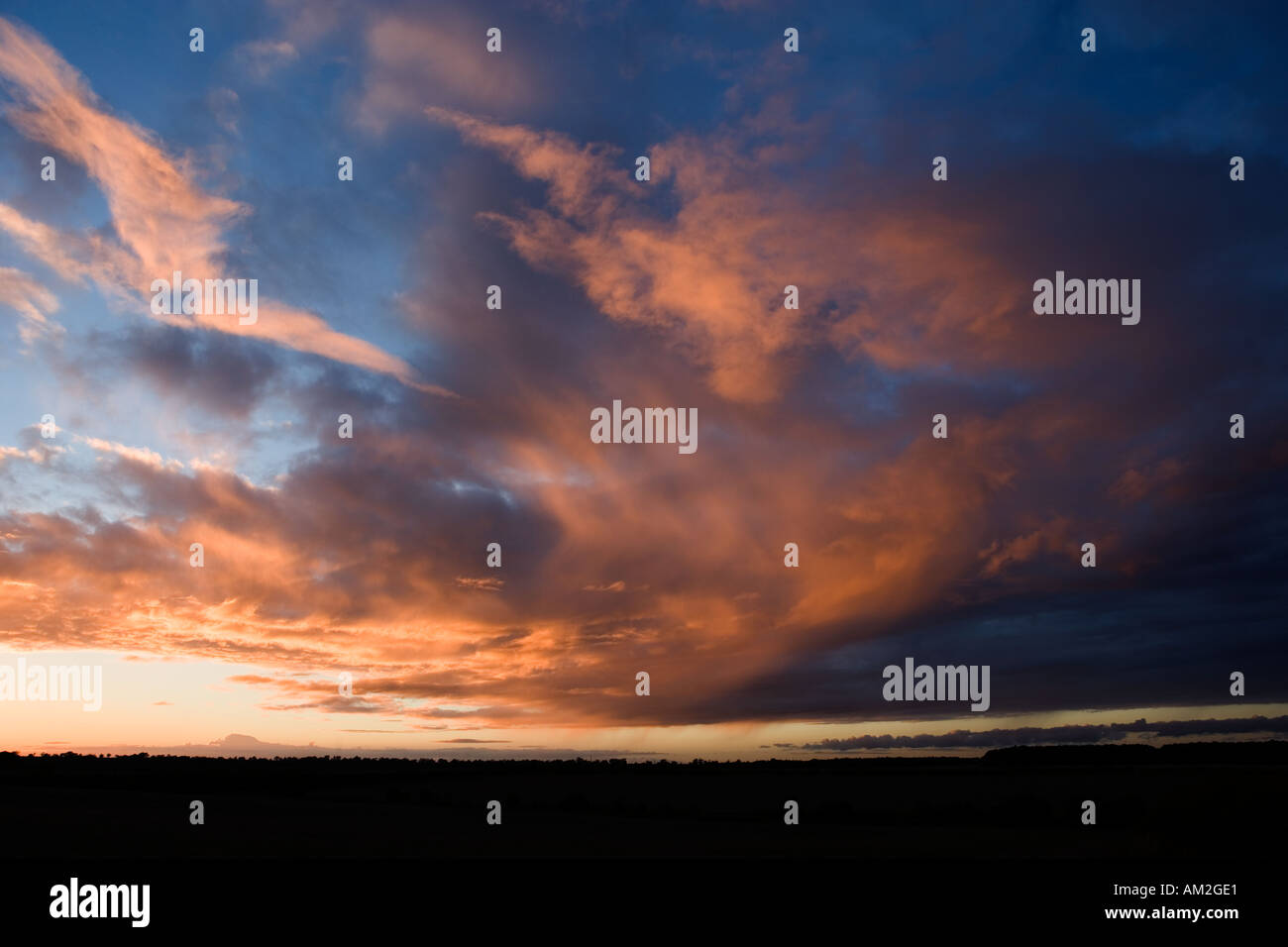 Clearing storm clouds at sunset uk Stock Photo - Alamy