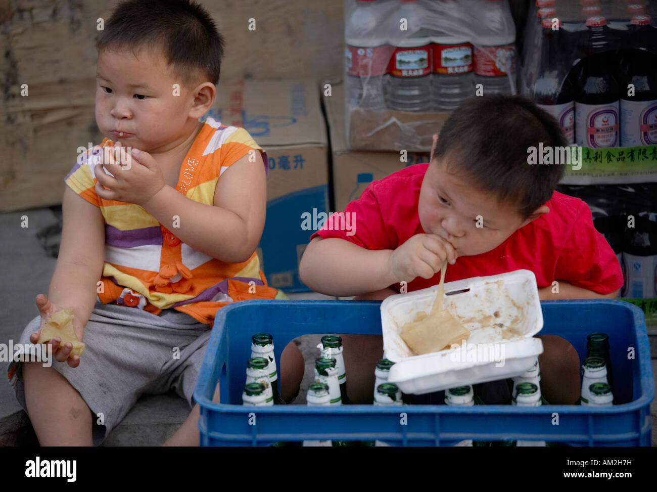 Two chinese toddlers eating outside in hutong Beijing China Stock Photo ...