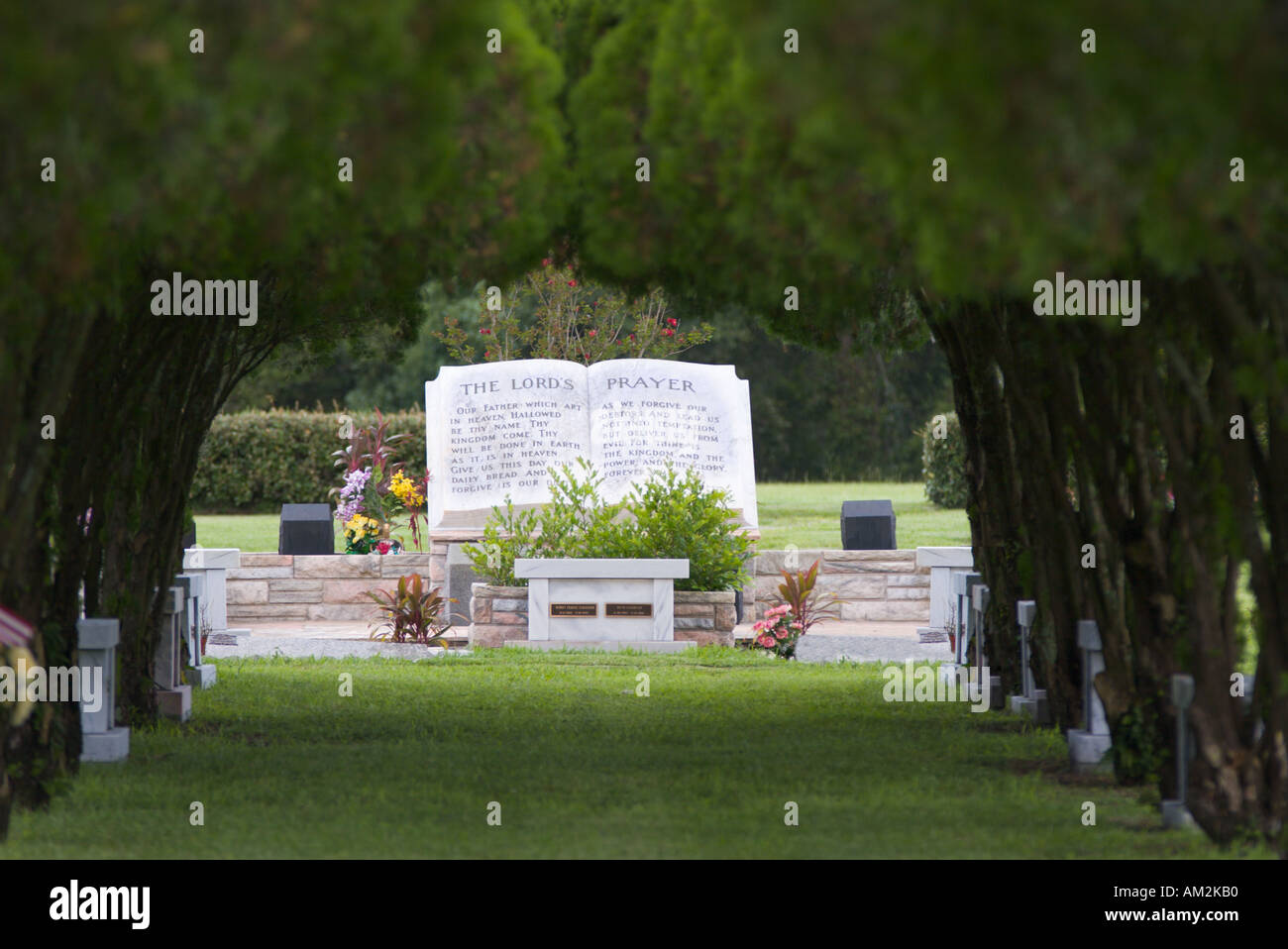 Display of The Lords Prayer at tree lined worship area of cemetery in ...