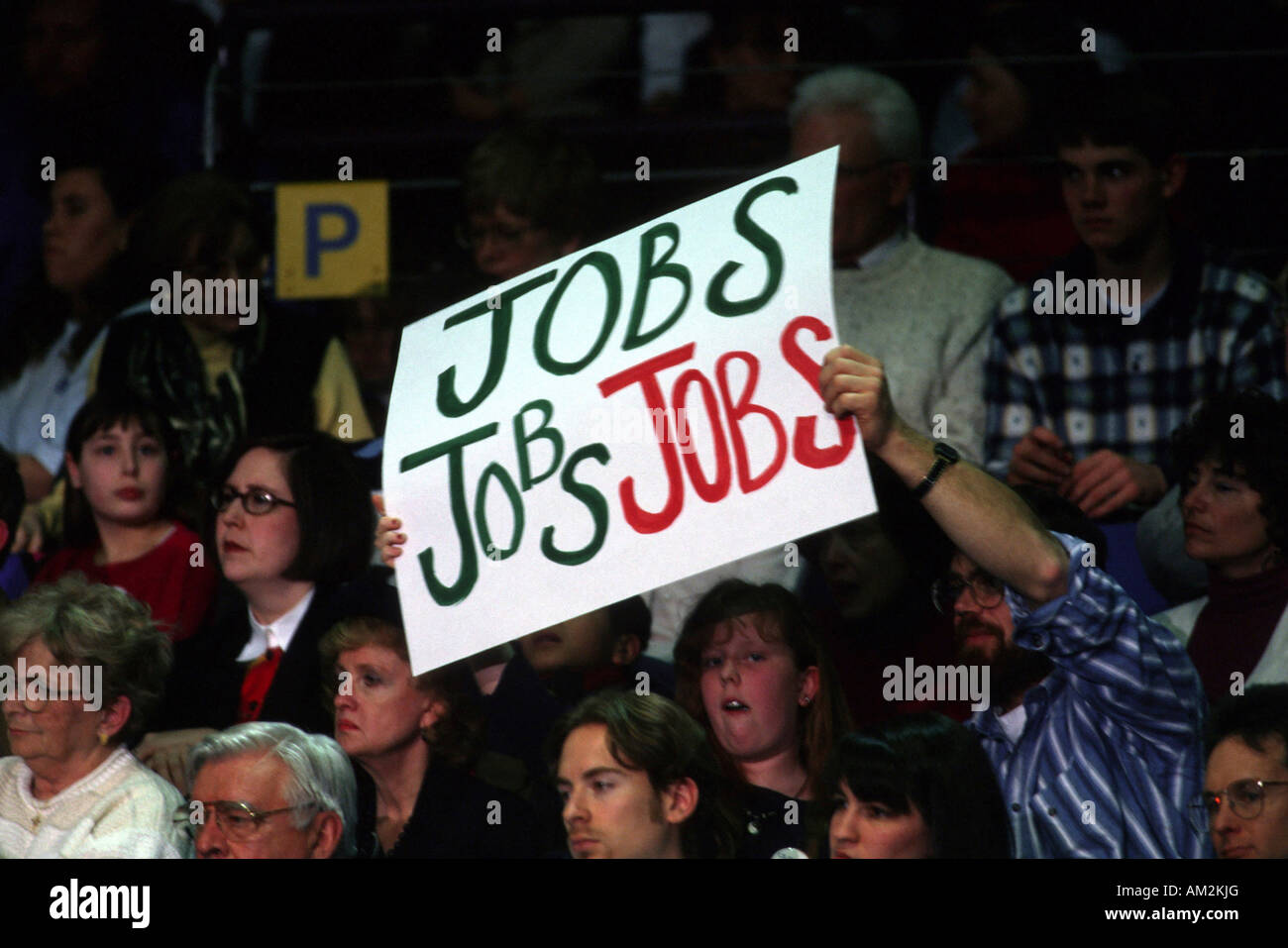 Man holding sign at a political campaign rally Stock Photo - Alamy