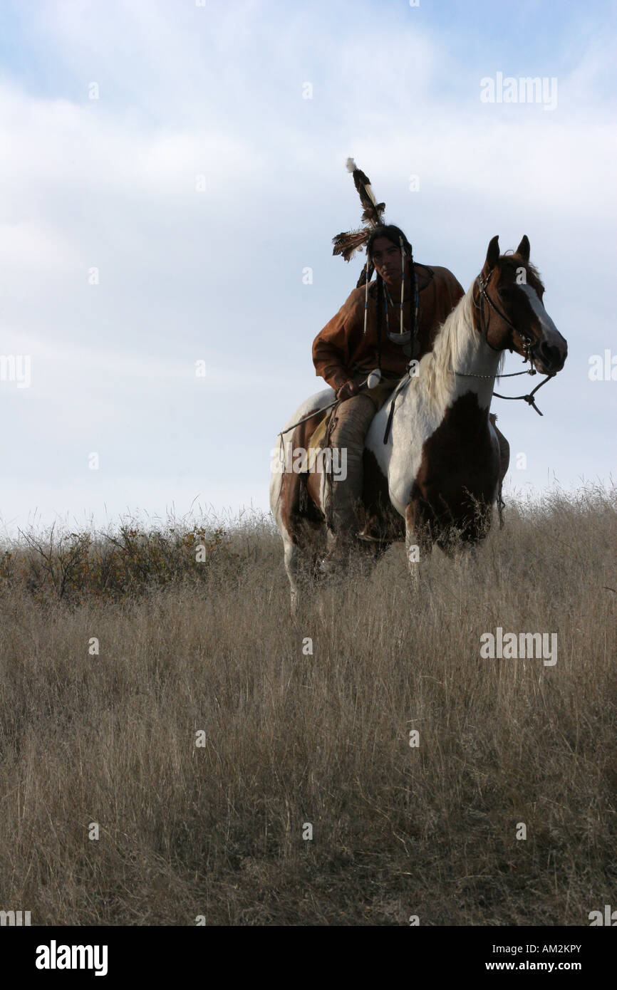 A Native American Indian man sitting bareback on a horse leaning ...