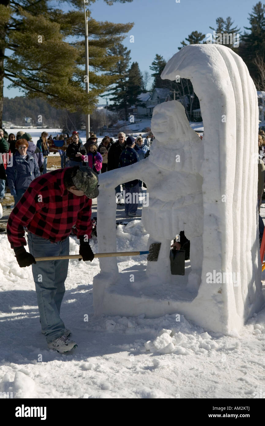 A man shapes snow sculpture with an ice breaker at Saranac Lake annual ...