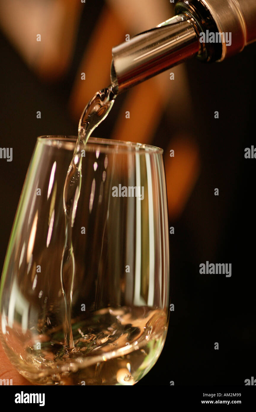 white wine being poured into a glass Stock Photo - Alamy