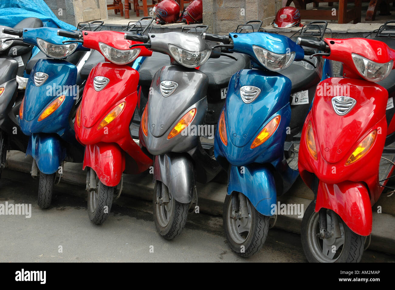 Coloured scooters in a row Stock Photo - Alamy